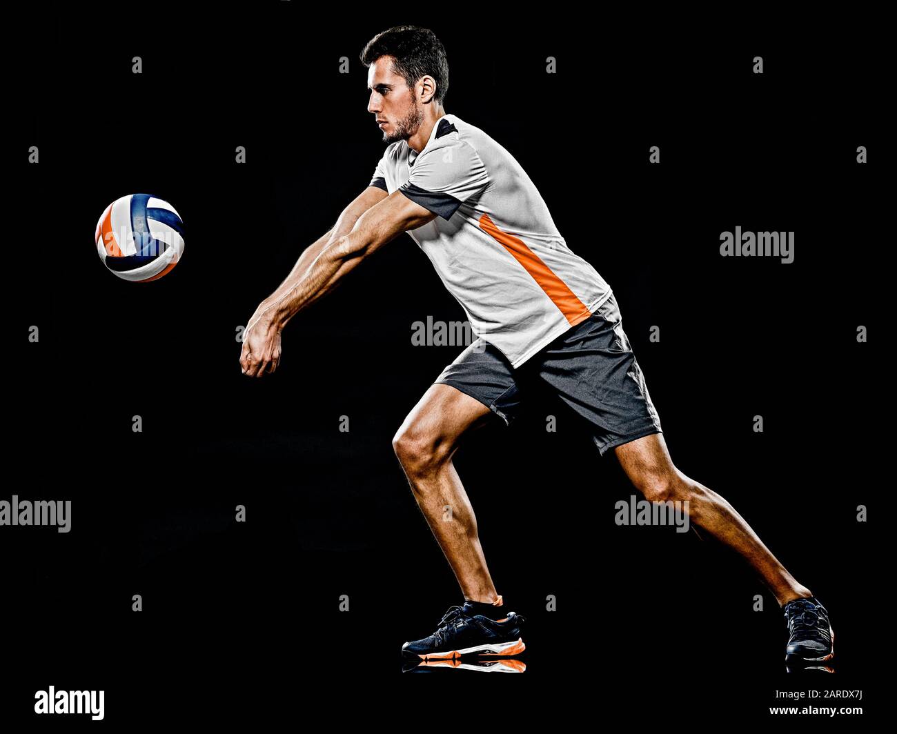 one caucasian young volley ball player man in studio isolated on black ...