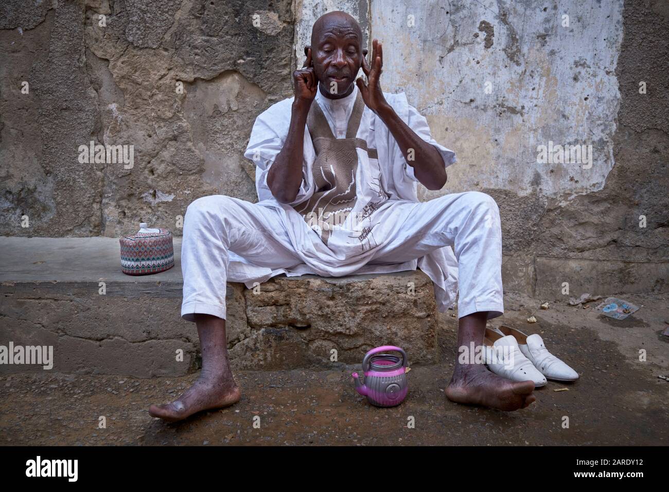 Muslim man doing wudu in preparation for prayers. Wudu is the Islamic ...