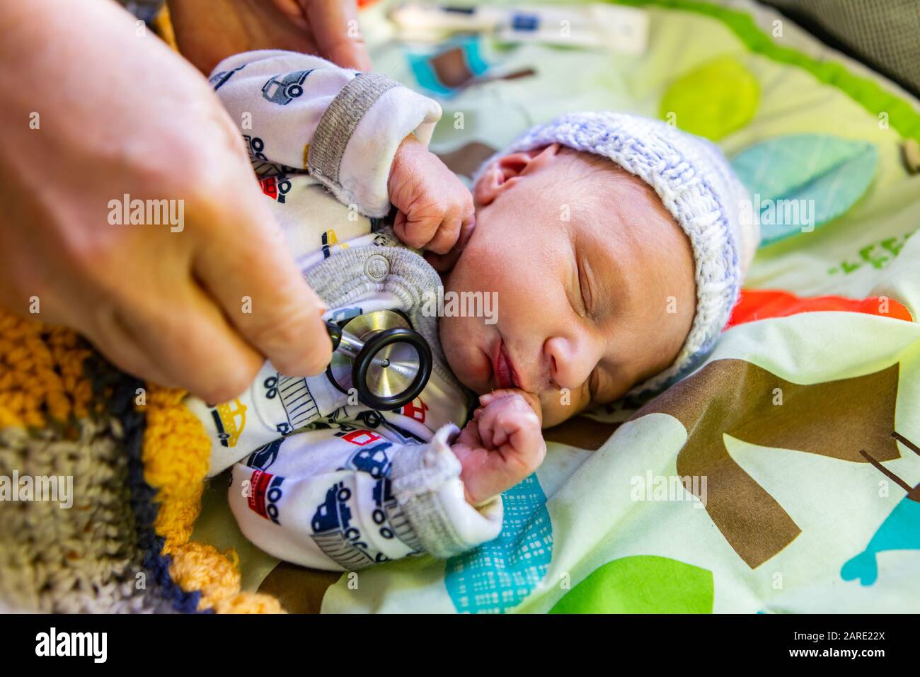 First health checks of new born baby boy, seen close up as obstetrician ...