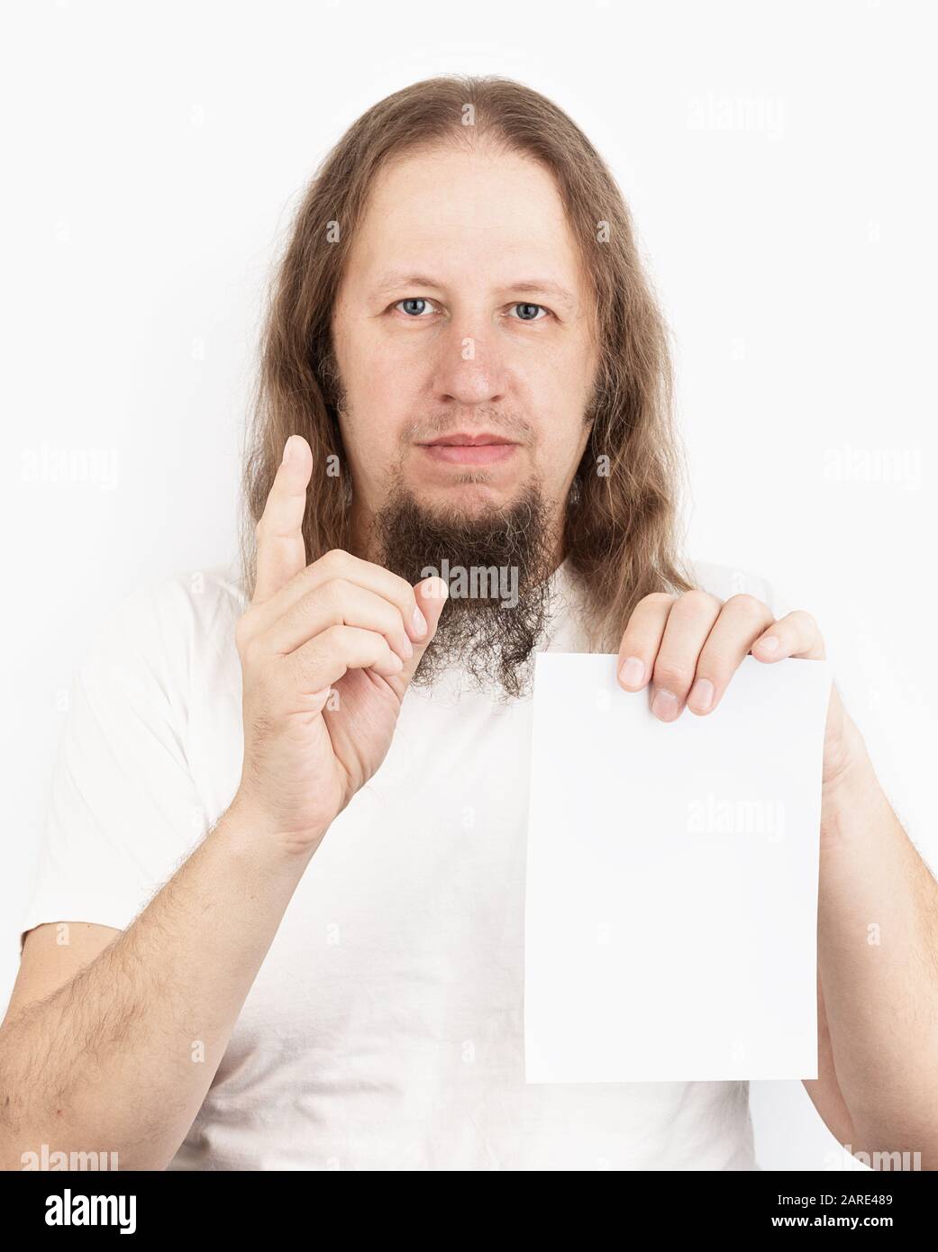 A man with long hair in white t-shirt keeping a blank paper Stock Photo ...