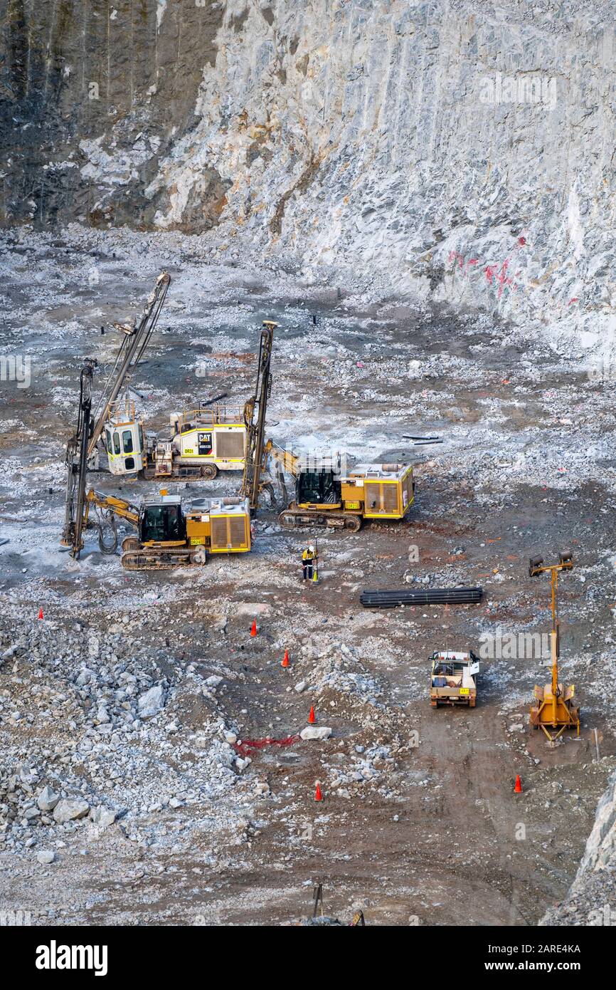 Drill rigs on production floor of open pit gold mine. Western Australia ...