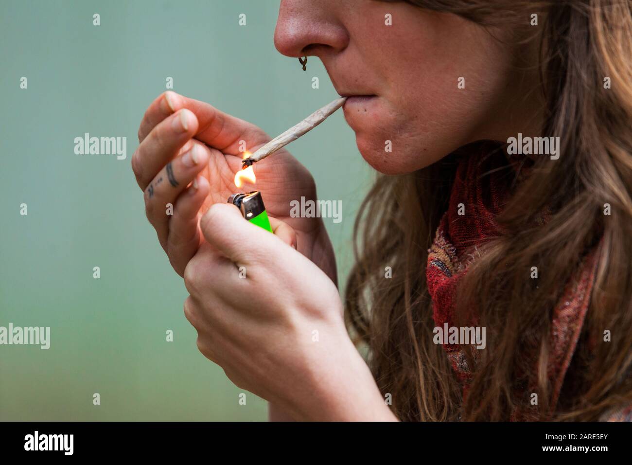 Closeup cropped shot of caucasian woman's face with hand rolled ...