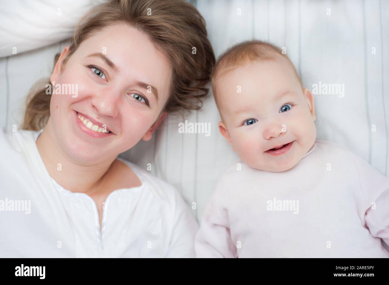 Mom and daughter lie on her back Stock Photo - Alamy