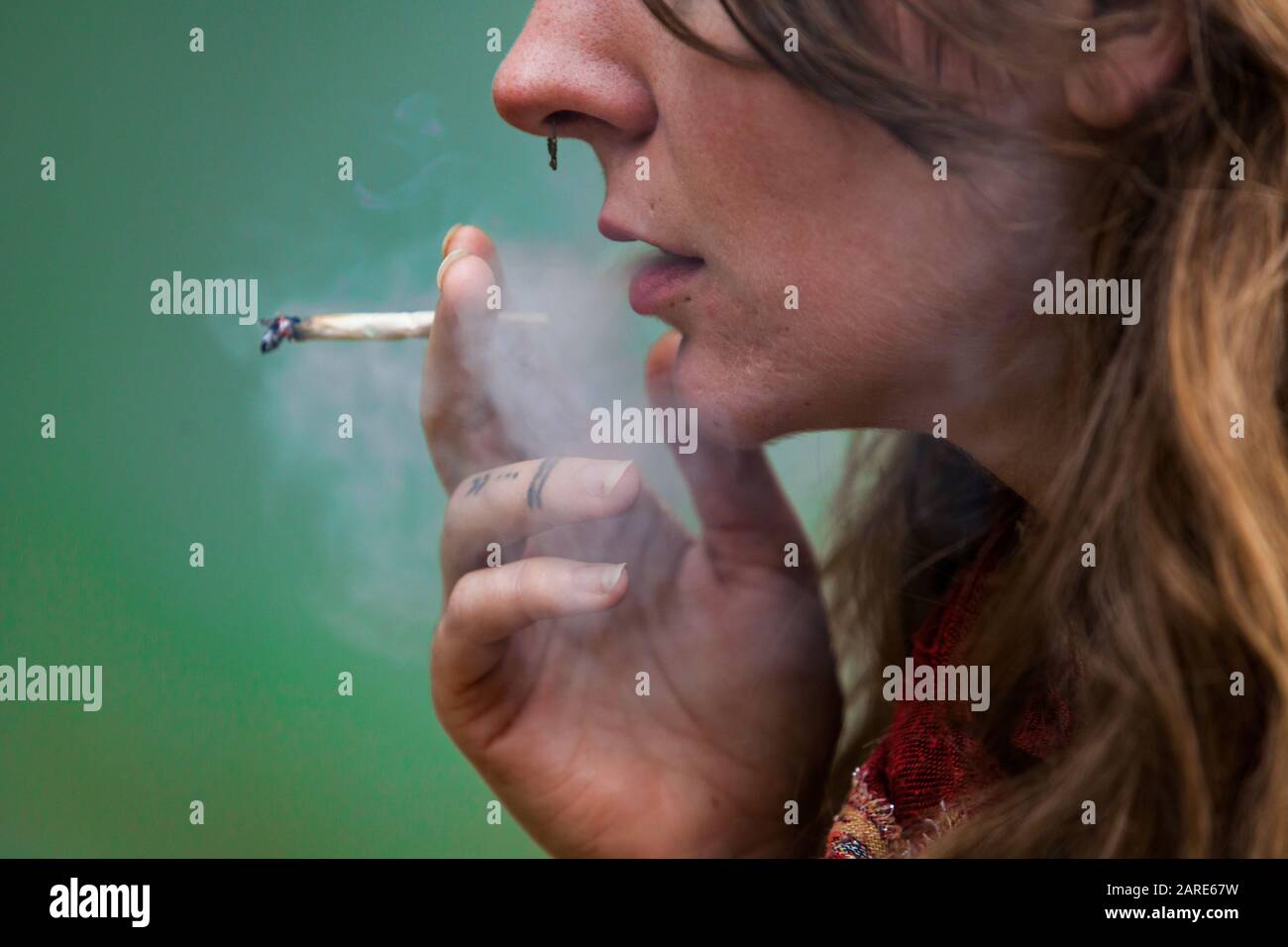 Closeup cropped shot of lower half of caucasian woman's face smoking ...