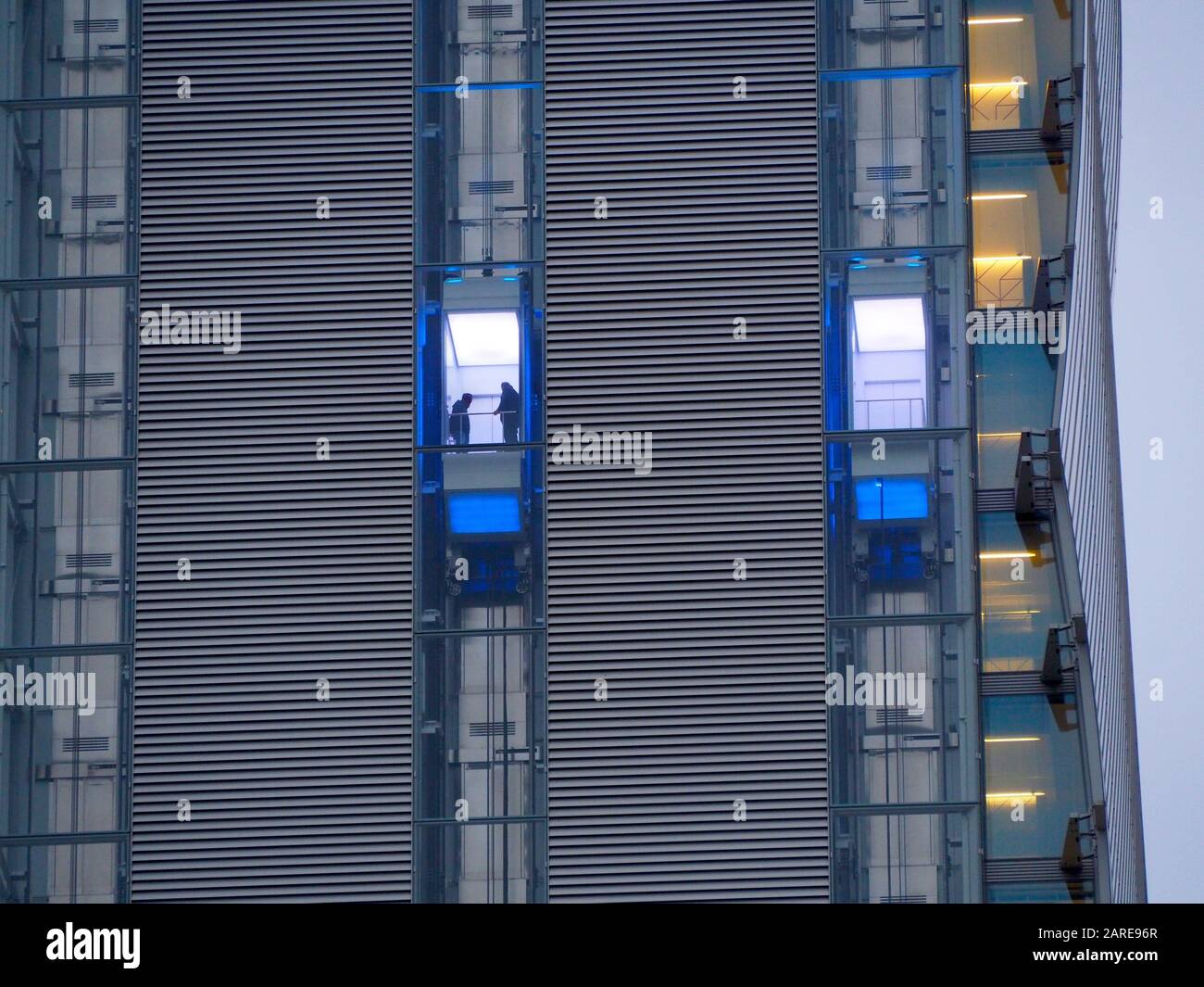 Moving outdoor glass elevators of a modern building Stock Photo - Alamy