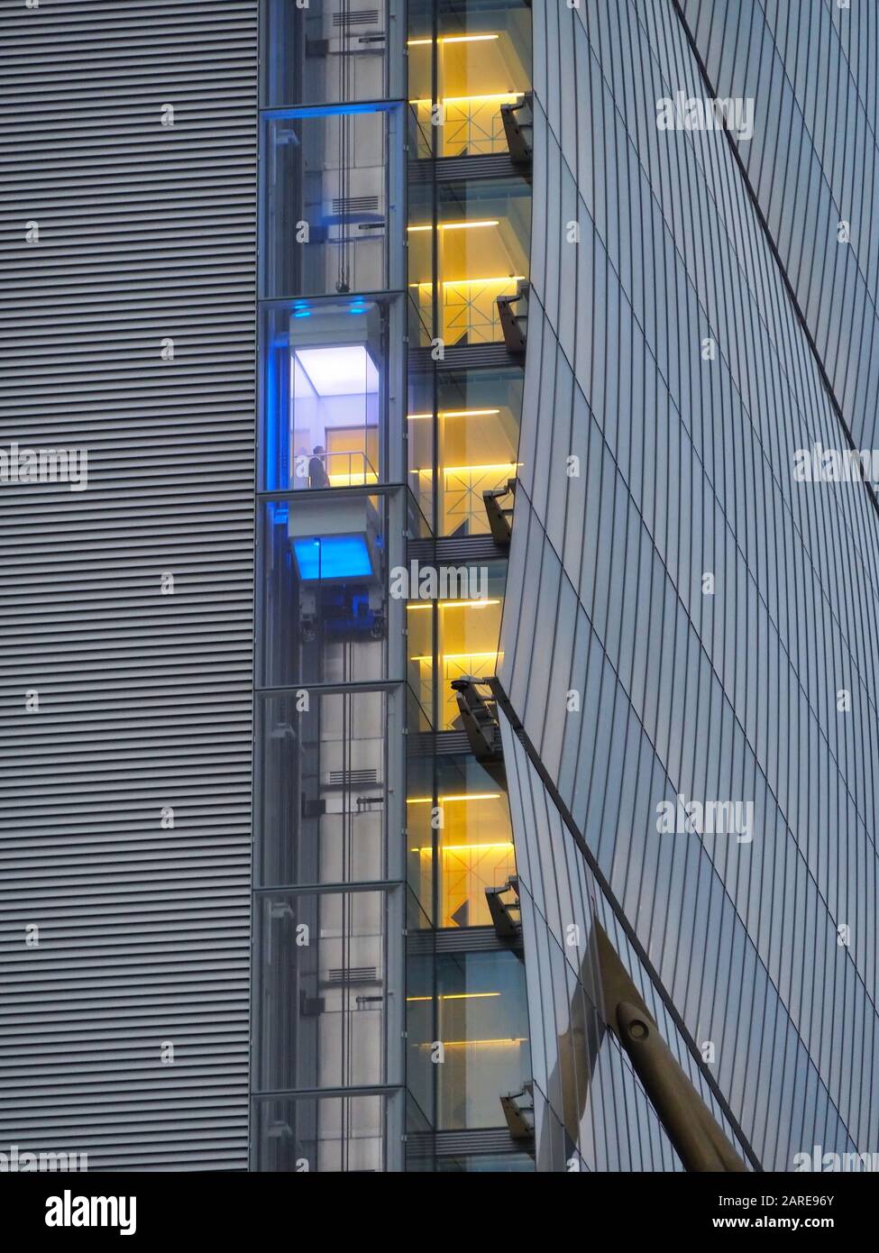 Vertical shot of a moving outdoor glass elevator of a modern building ...