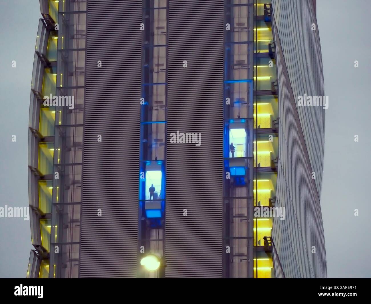 Moving outdoor glass elevators of a modern building Stock Photo - Alamy