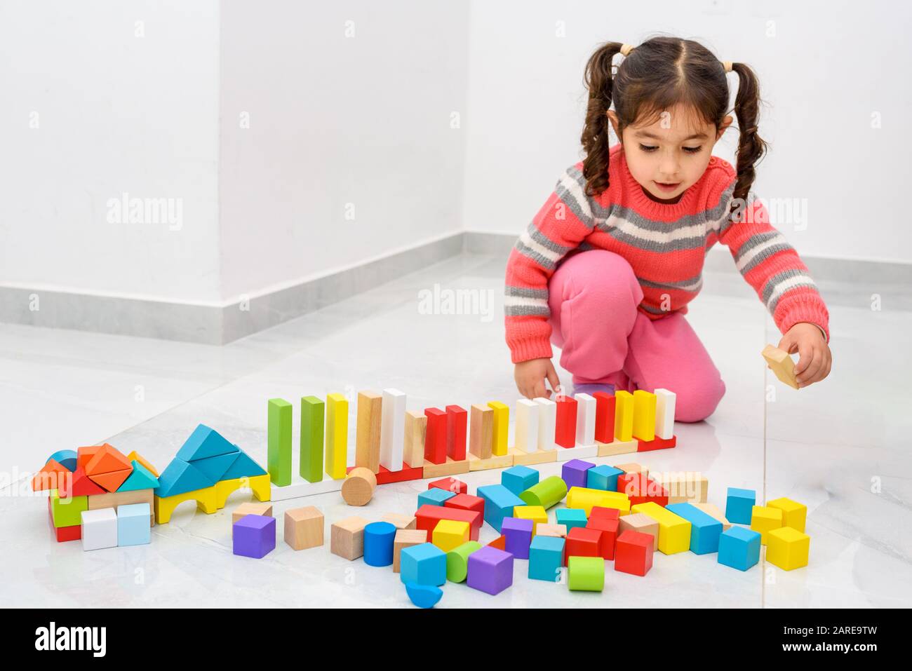 Cute toddler play with zero waste toys, different color and shape ...