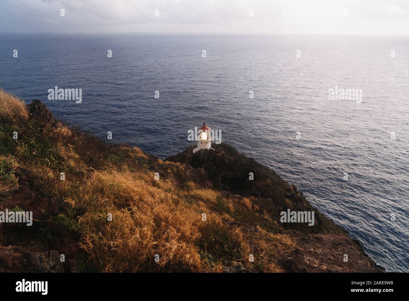 High angle shot of a lighthouse at the top of the cliff in the ocean ...