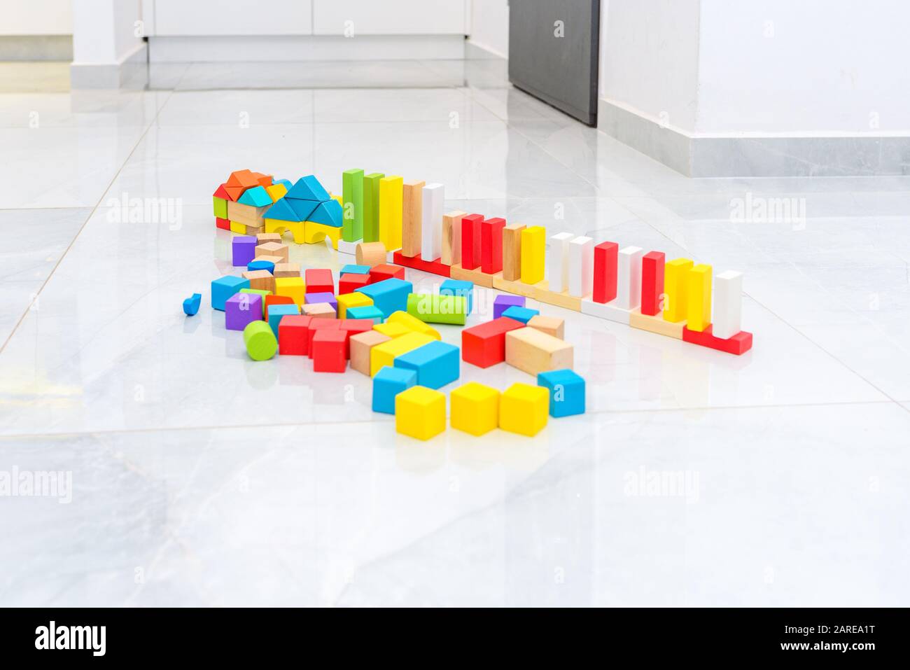 Different color and shape wooden toy building blocks in home on grey ...