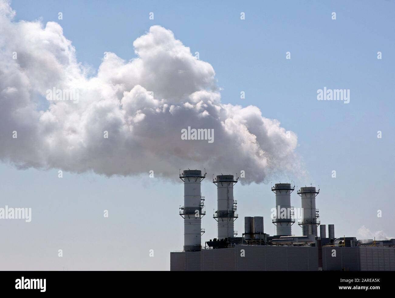 Exhaust gases leaving from the chimney of industrial factory building ...