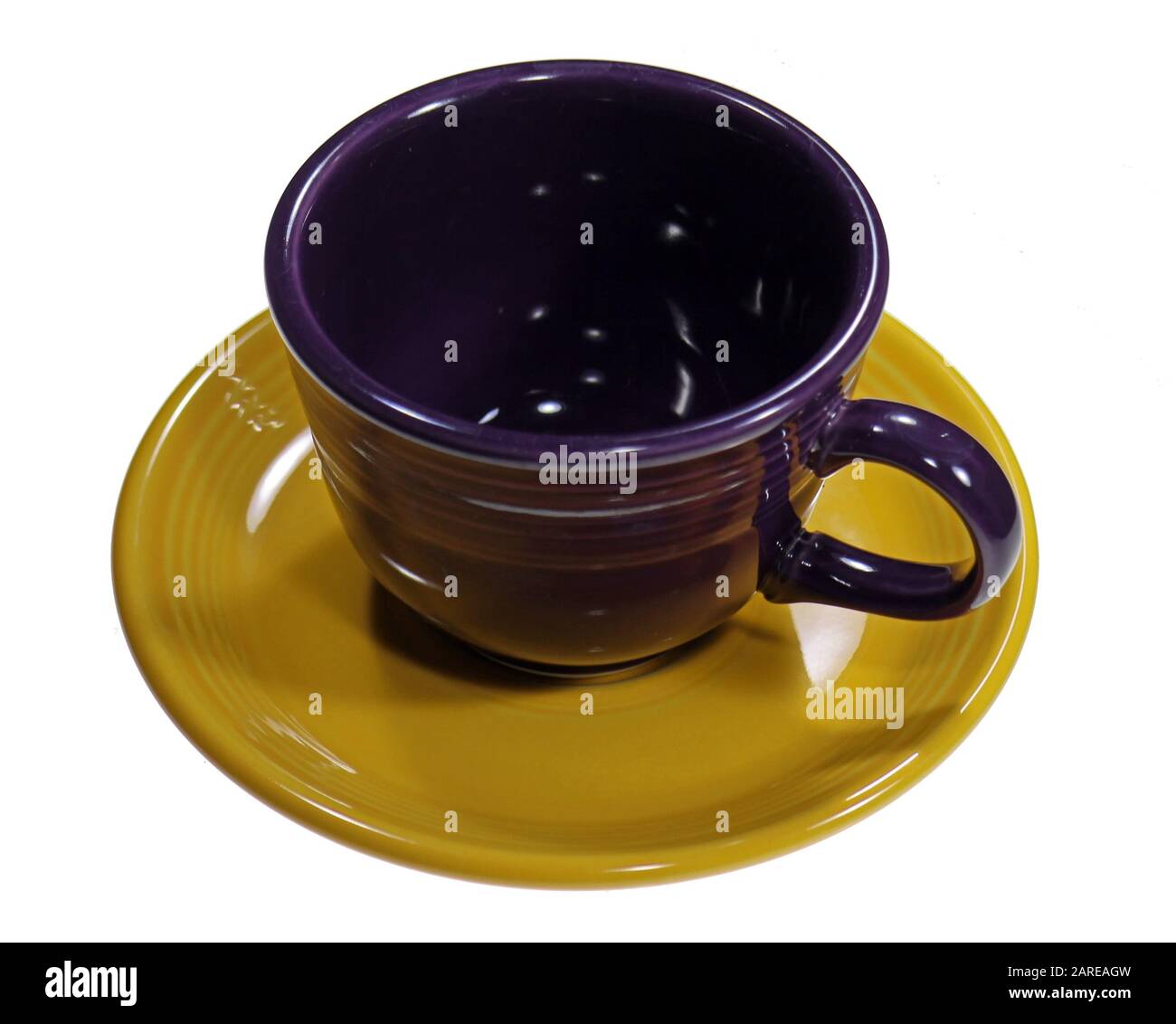 Overhead shot of an empty violet cup placed in a dark yellow small ...
