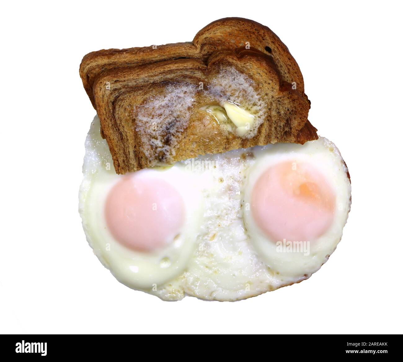 Breakfast meal of sunny side up and toasted bread coated with butter ...