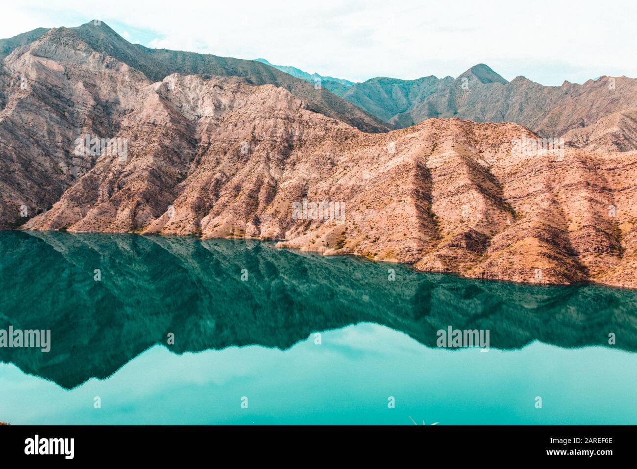 Landscape with mountains, clouds, water, and roads in a Central Asian ...