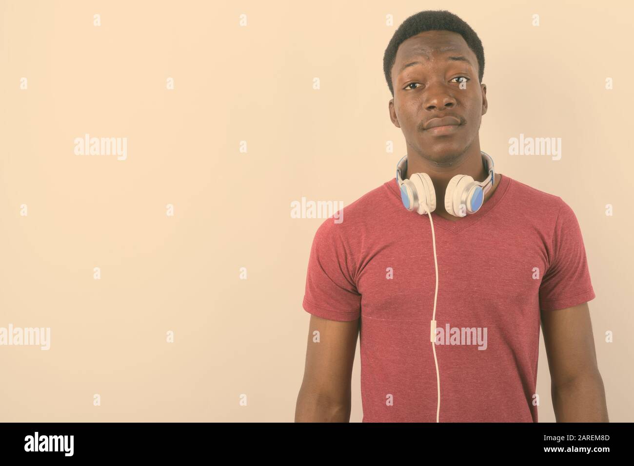 Young handsome African man wearing headphones against white background ...