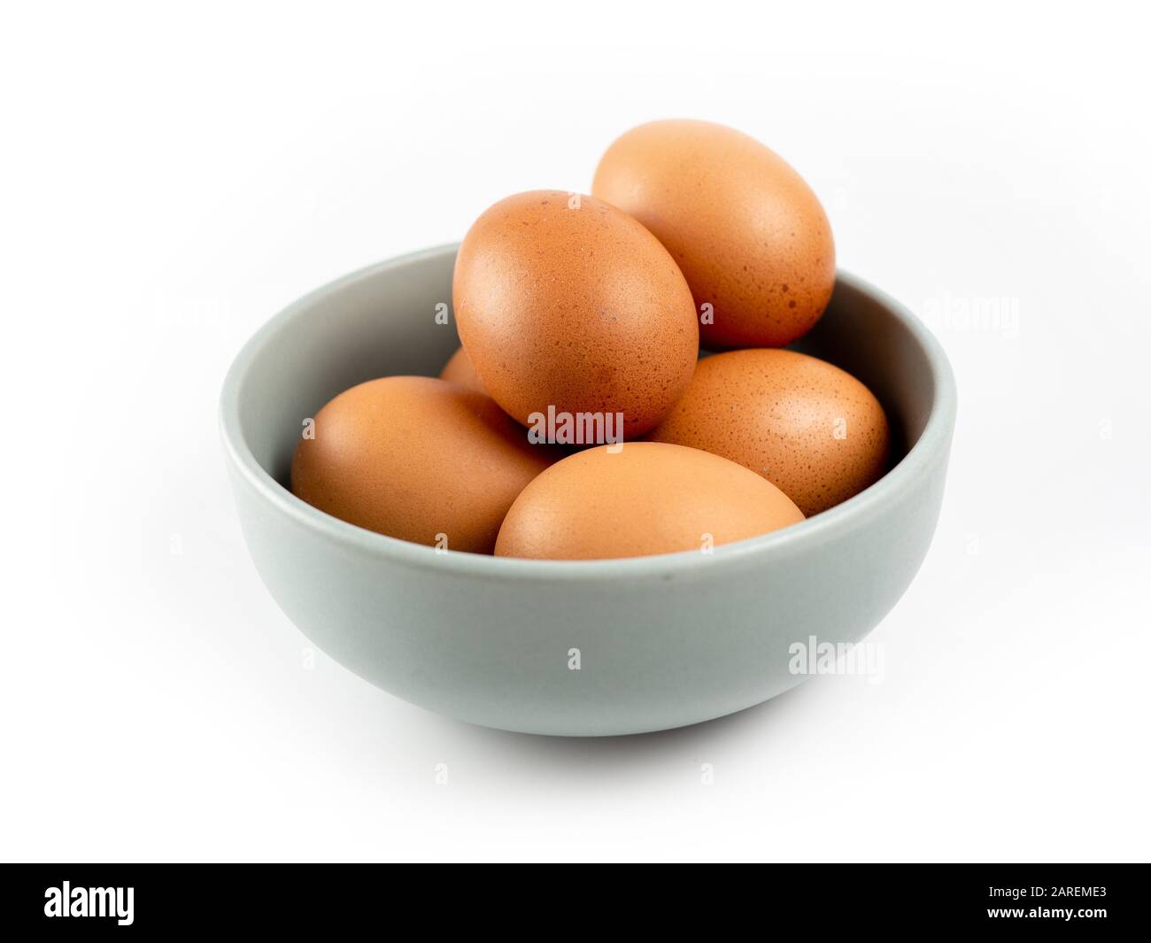 Put eggs in one bowl on white background Stock Photo - Alamy
