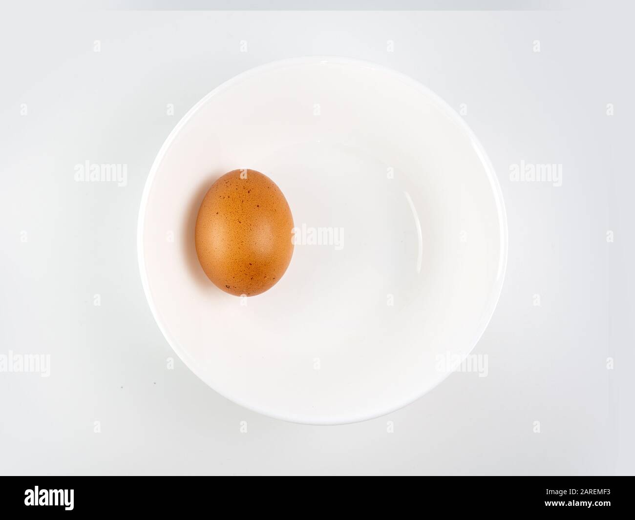 Put eggs in one bowl on white background Stock Photo - Alamy