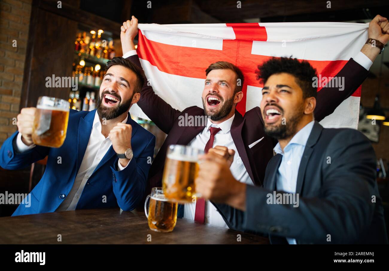 Business men in pub cheering for a sporting event Stock Photo - Alamy