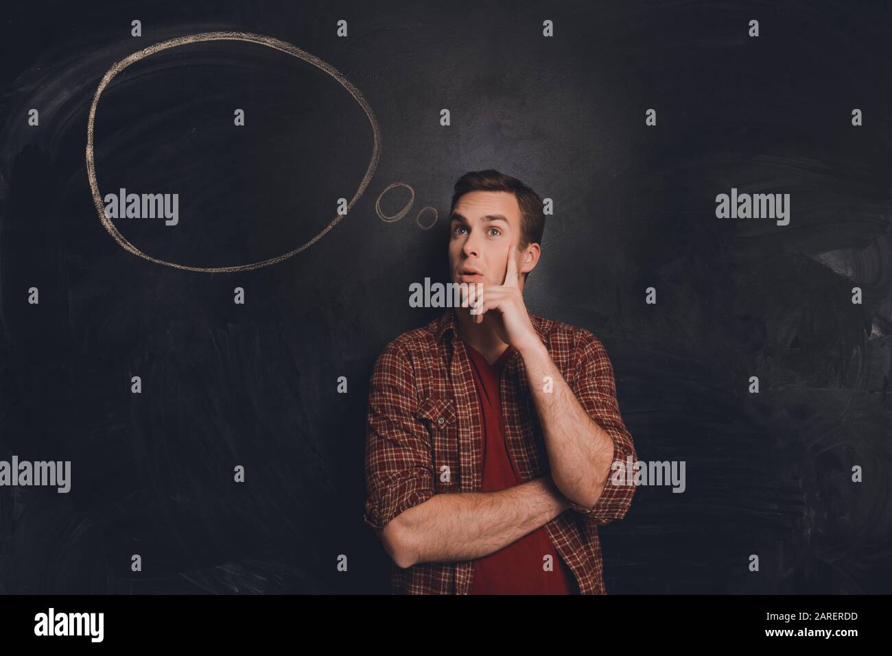 Portrait of minded young man having an idea Stock Photo - Alamy
