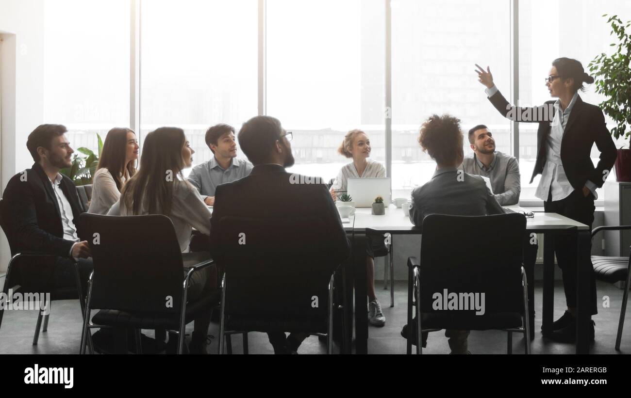 Boss talking to employees, having brainstorm meeting in office Stock ...