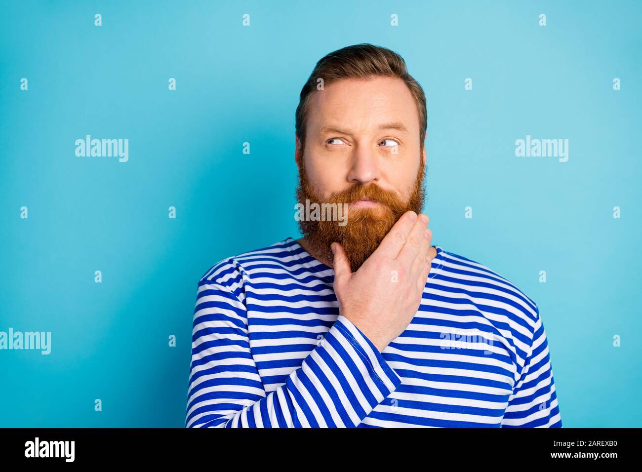 Portrait of minded pensive ginger hair beard man look copyspace think ...