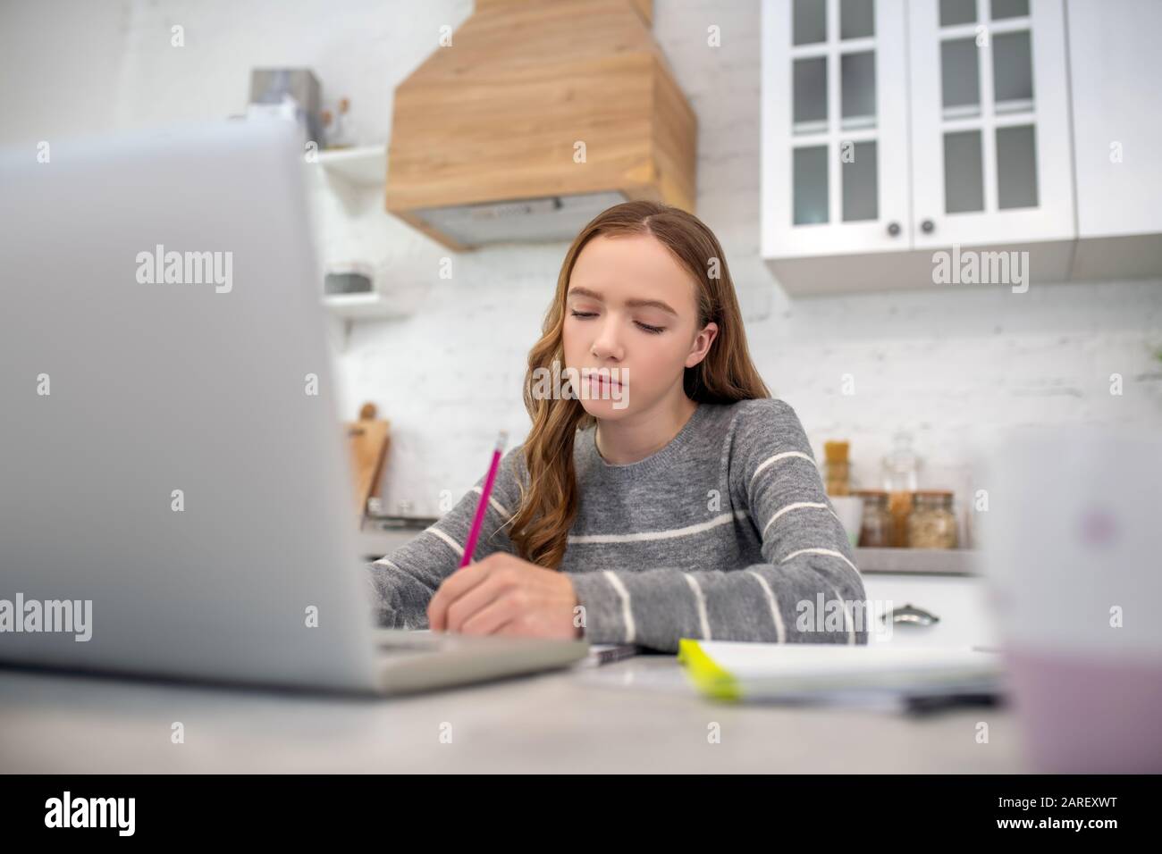 Pretty girl with long hair looking bored Stock Photo - Alamy