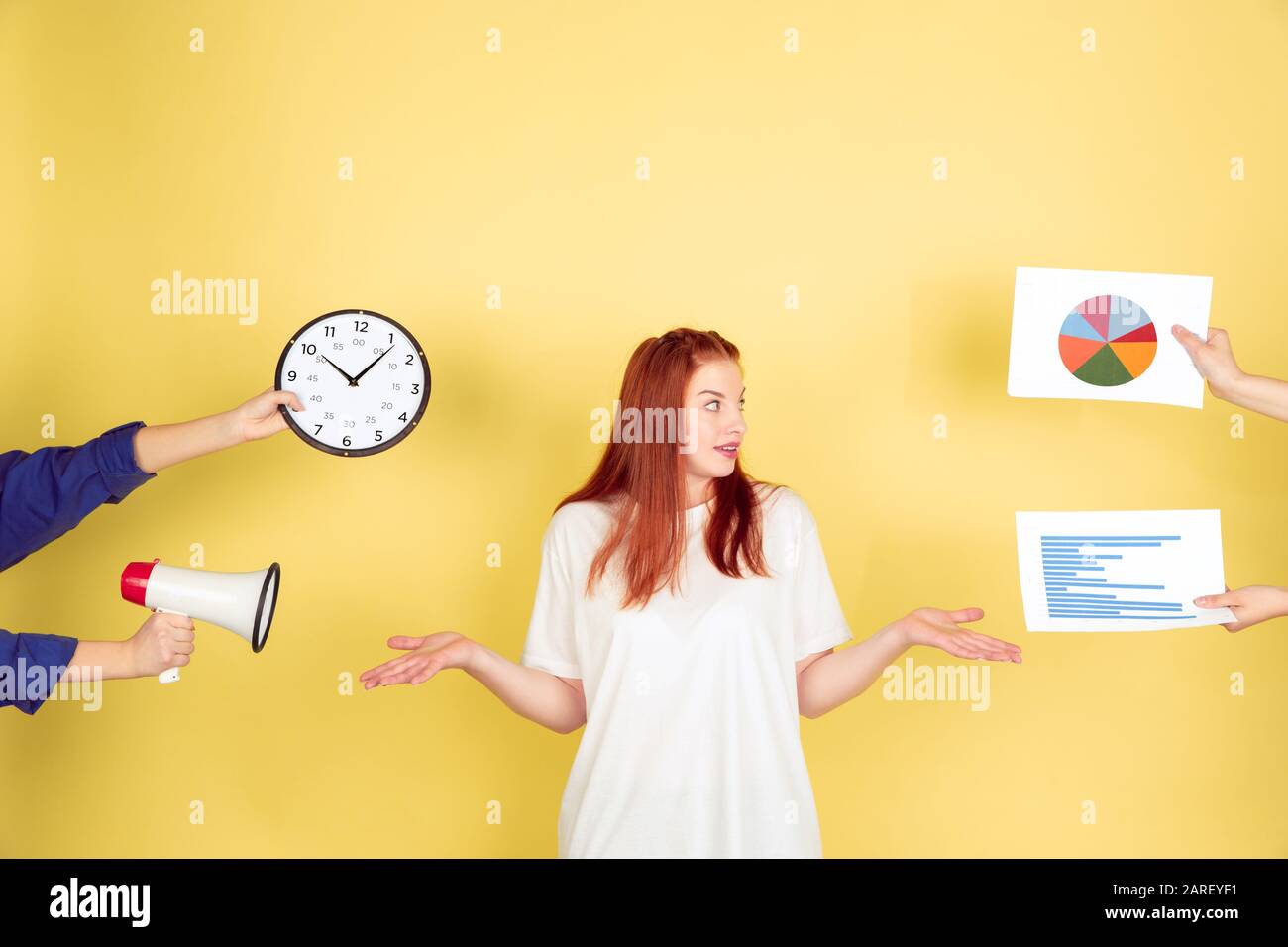 Choosing. Caucasian young woman's portrait on yellow studio background ...