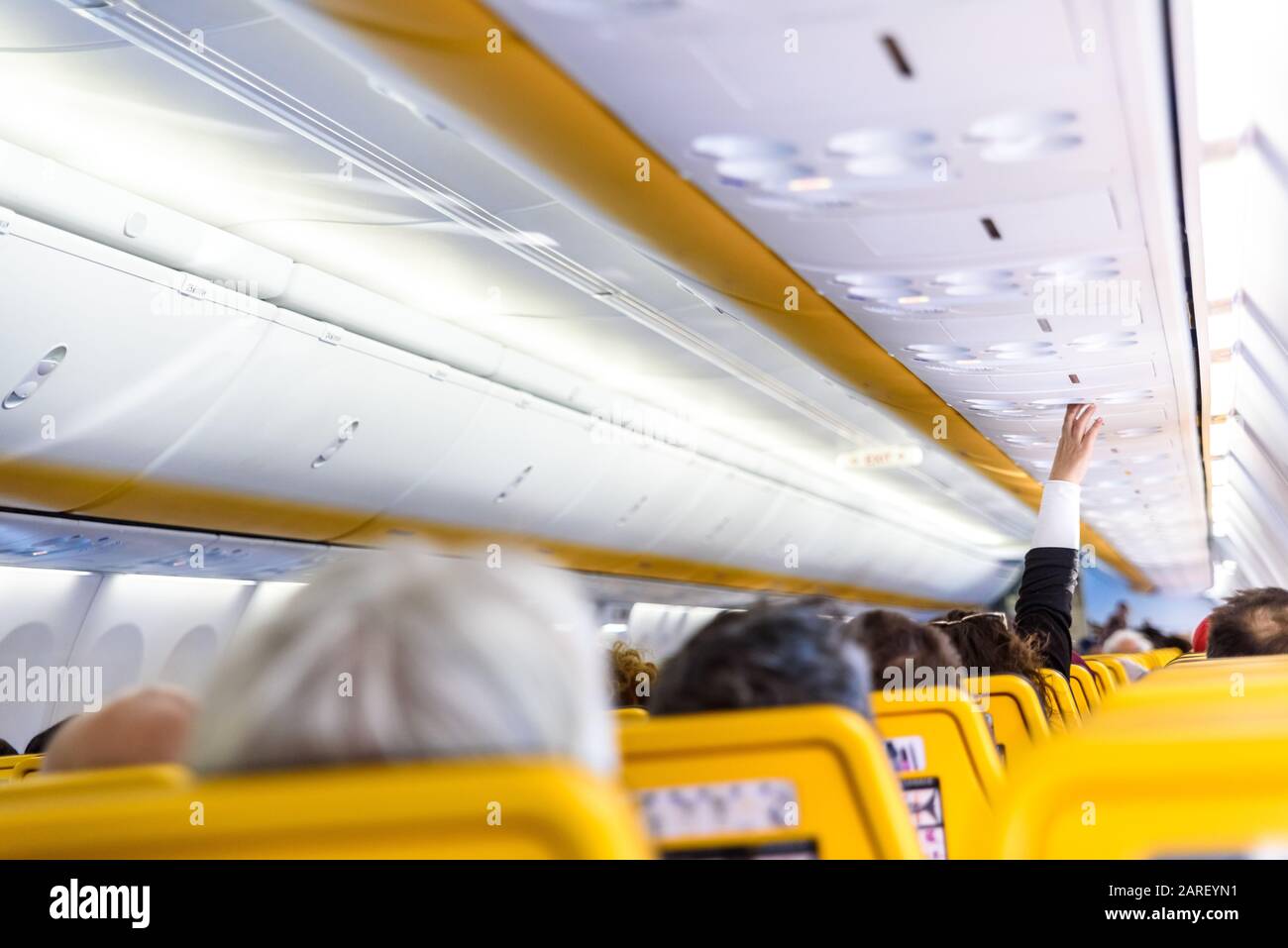 Business passenger on a plane requesting assistance from stewardesses ...