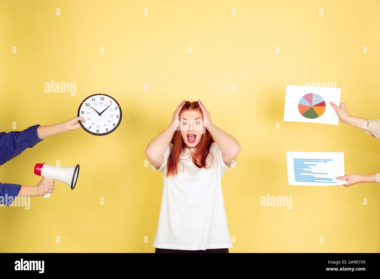 Astonished. Caucasian young woman's portrait on yellow studio ...