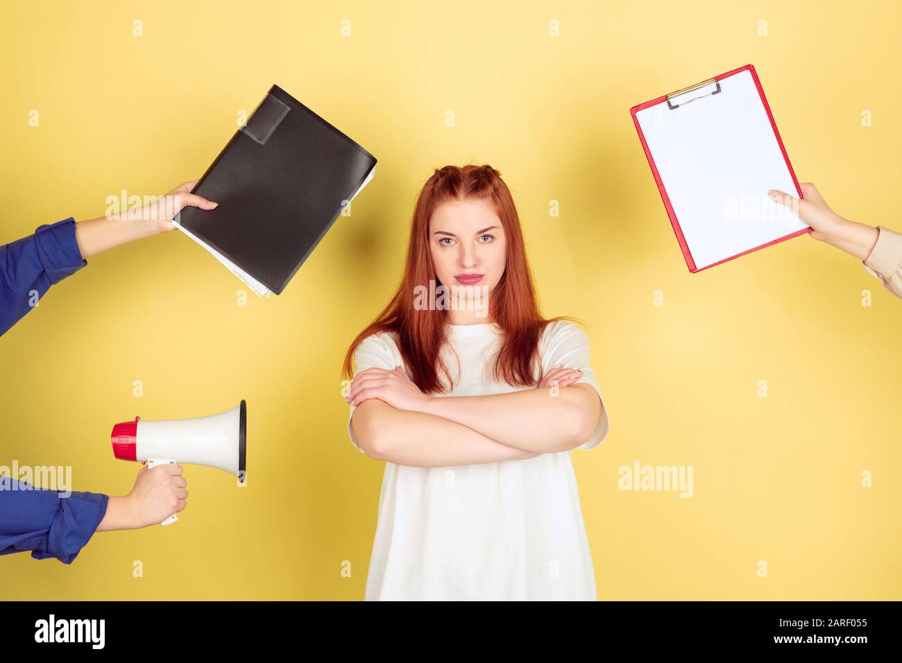 Work hard. Caucasian young woman's portrait on yellow studio background ...