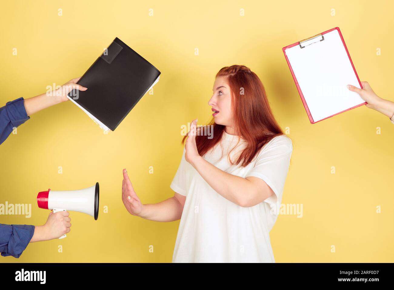 No reports. Caucasian young woman's portrait on yellow studio ...