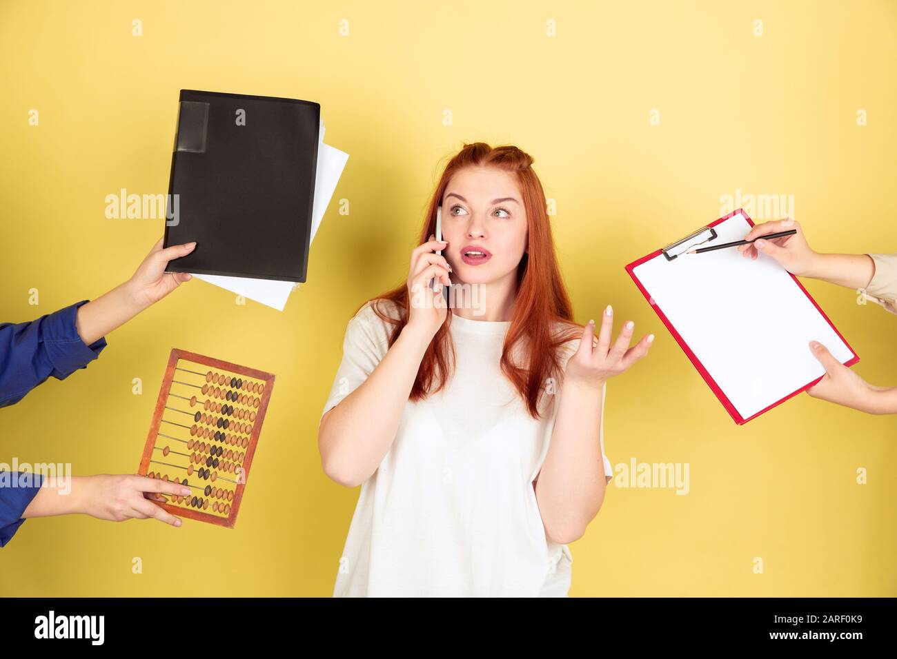 Deadline. Caucasian young woman's portrait on yellow studio background ...