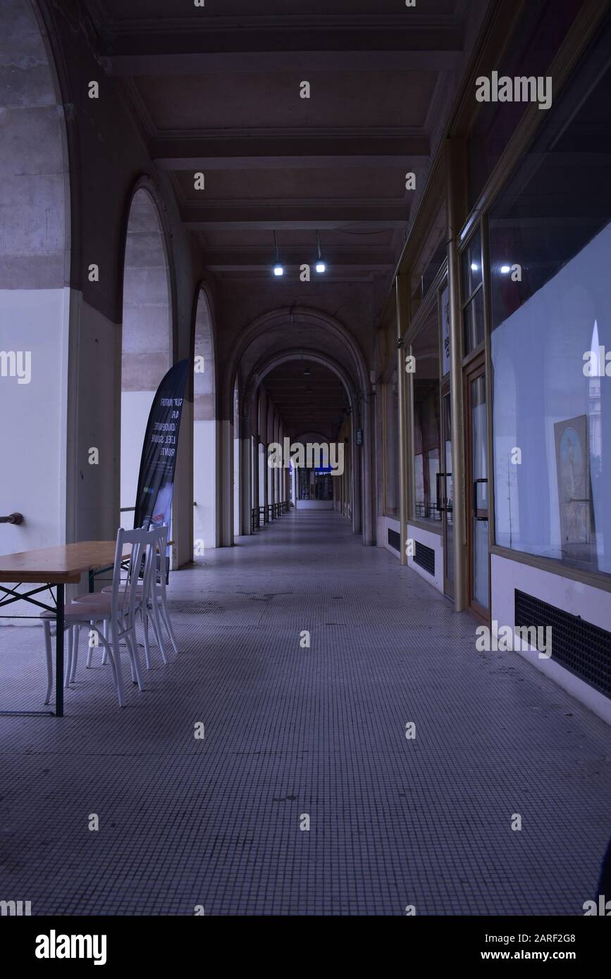 A table with chairs and a long passage Stock Photo - Alamy