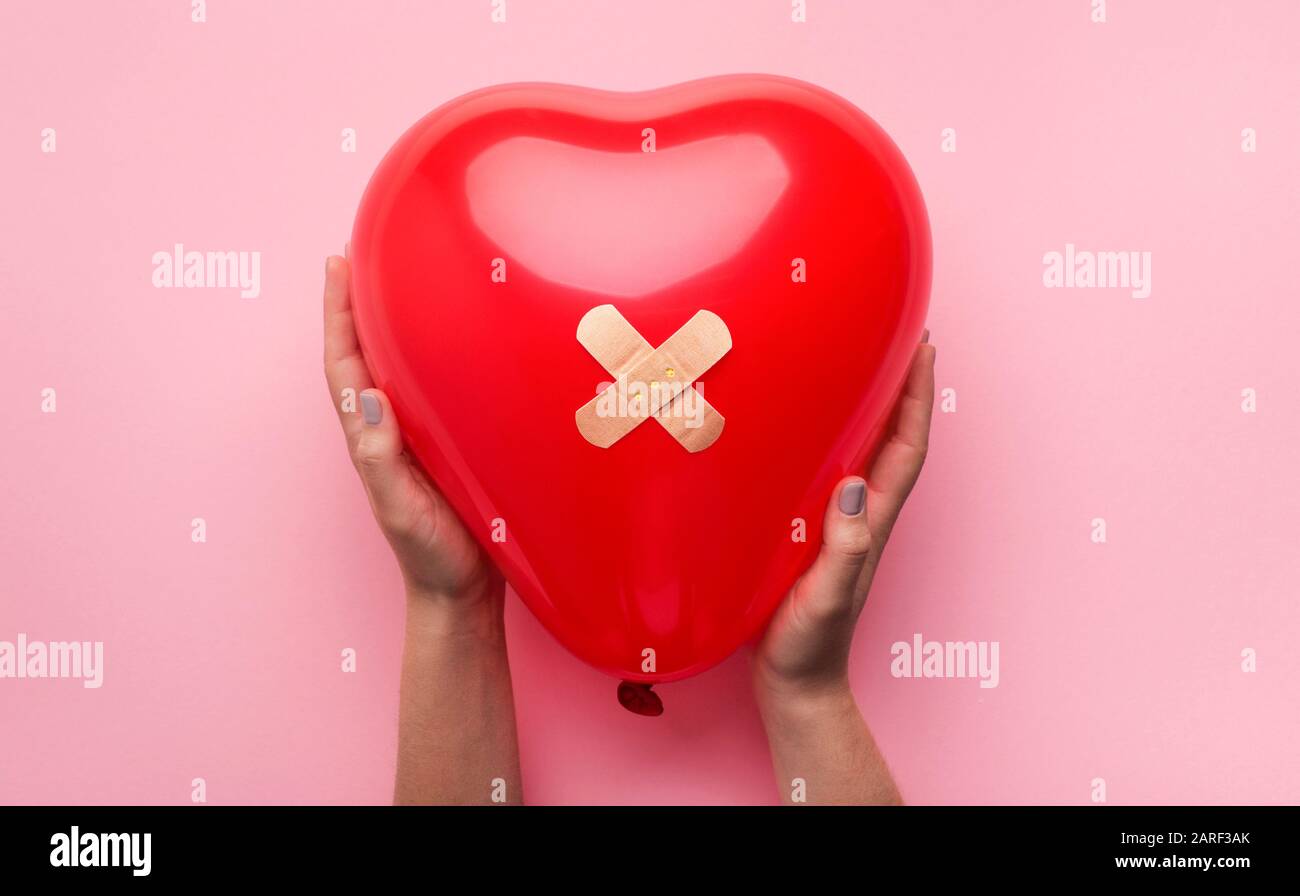 First Aid Band Plaster Strip Medical Patch glued on red heart balloon ...