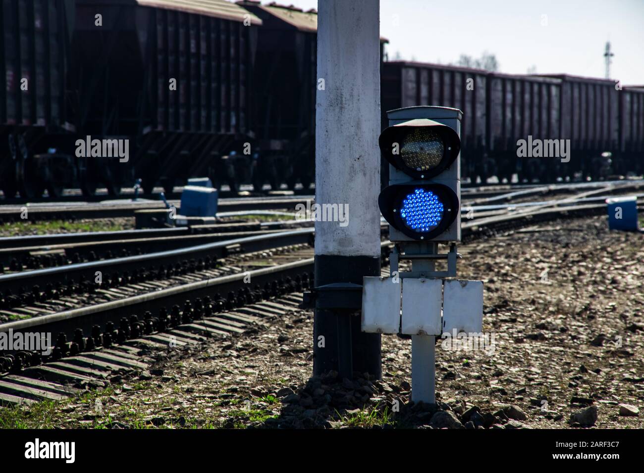 Traffic light and train on the railway close up Stock Photo - Alamy