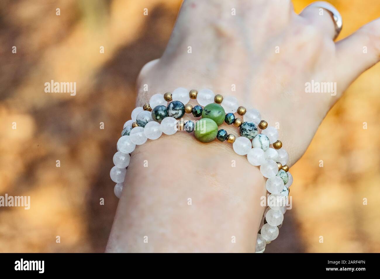 Mineral stone bracelet on female hand detail in forest background Stock ...