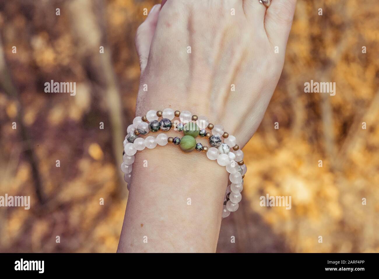 Mineral stone bracelet on female hand detail in forest background Stock ...