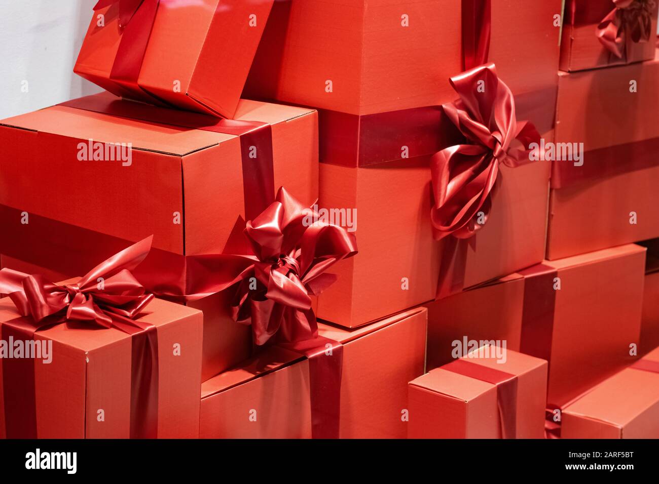 Pile of red boxes with bows gifts Stock Photo - Alamy