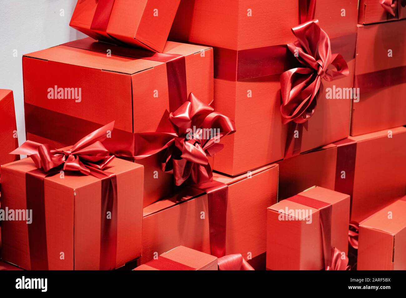 Pile of red boxes with bows gifts Stock Photo - Alamy