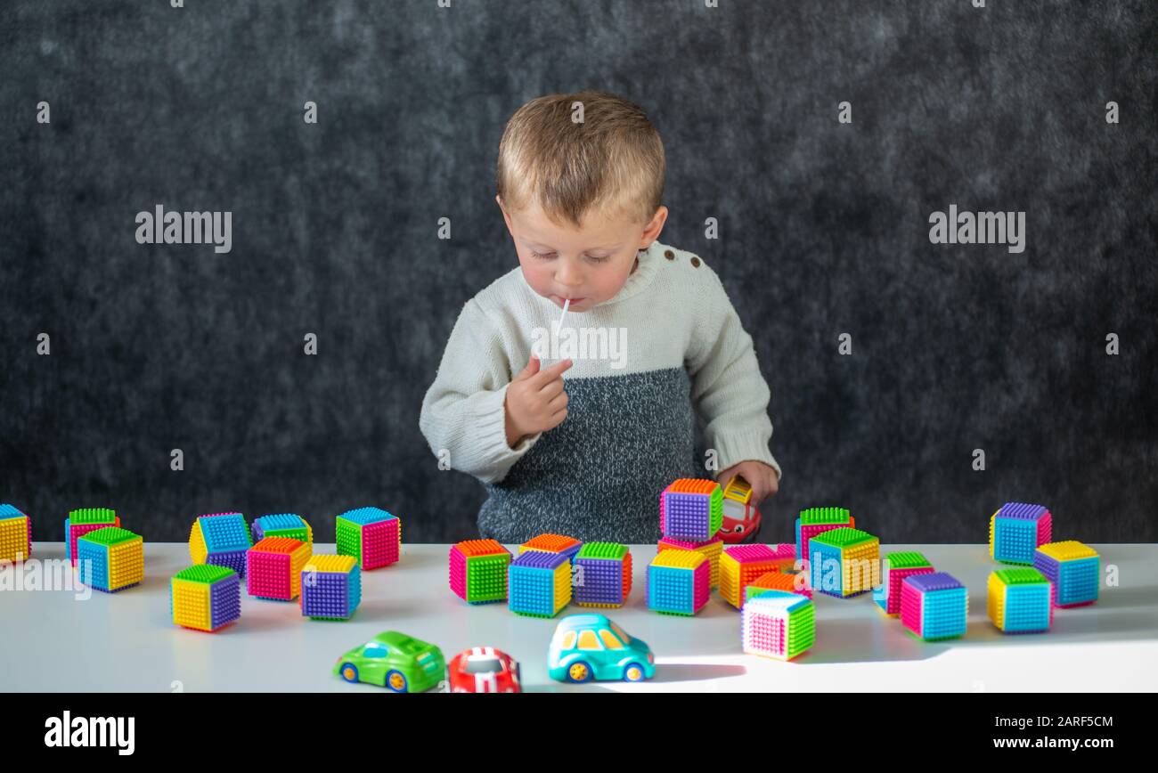 a two years old baby playing with cubes Stock Photo - Alamy