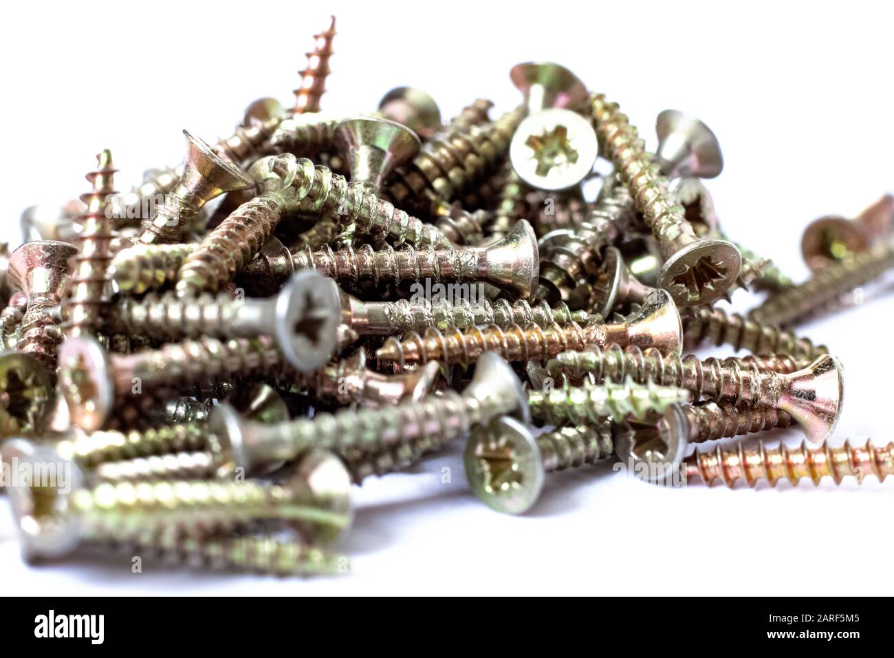 Pile of wood screws on white background Stock Photo - Alamy