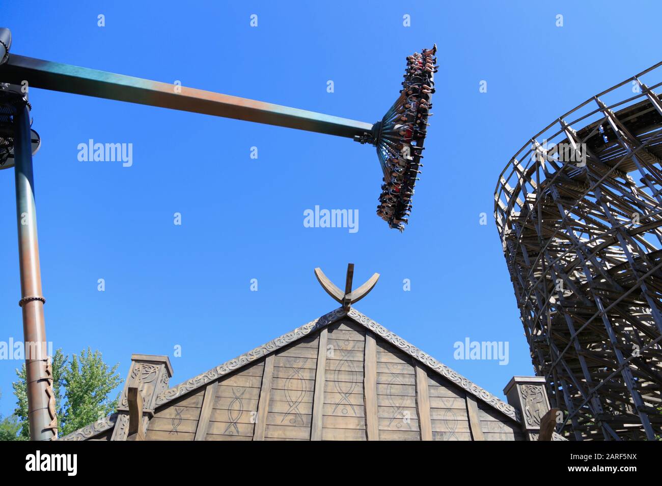 A group of young people up in the air on the viking inspired amusement ...