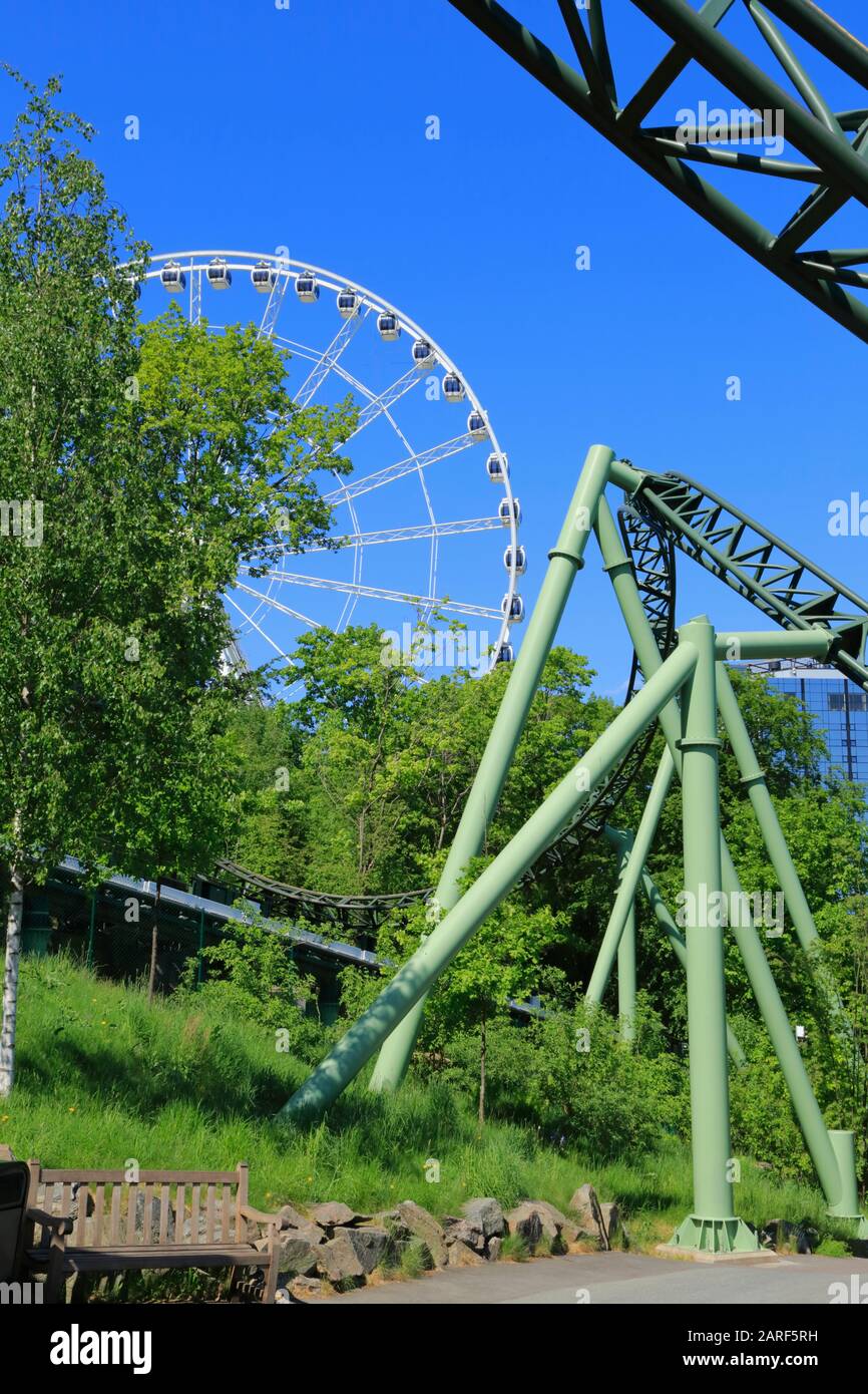 The big wheel and steel roller coaster tracks in Liseberg amusement ...