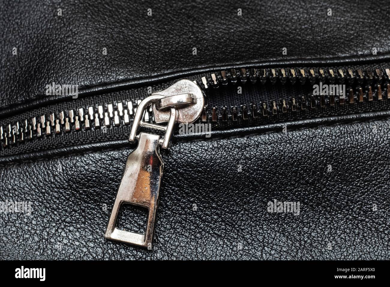 Metal clasp and zipper on leather closeup Stock Photo - Alamy