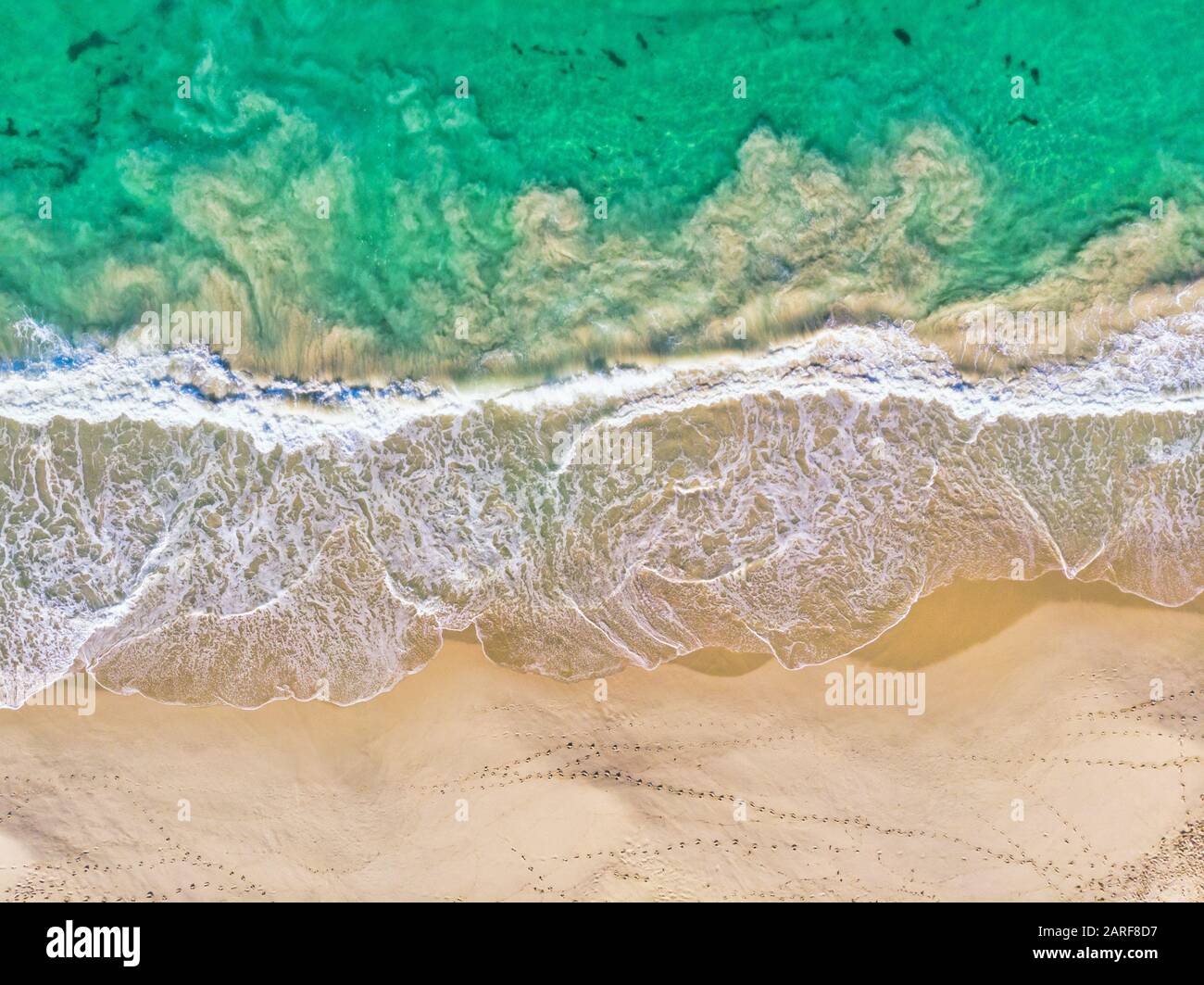 An aerial view of waves breaking onto the sand at City Beach in Perth ...