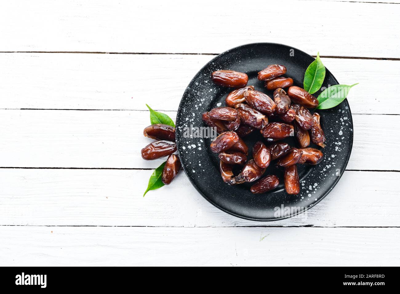 Dry date on a white wooden background. Top view. Free space for your ...