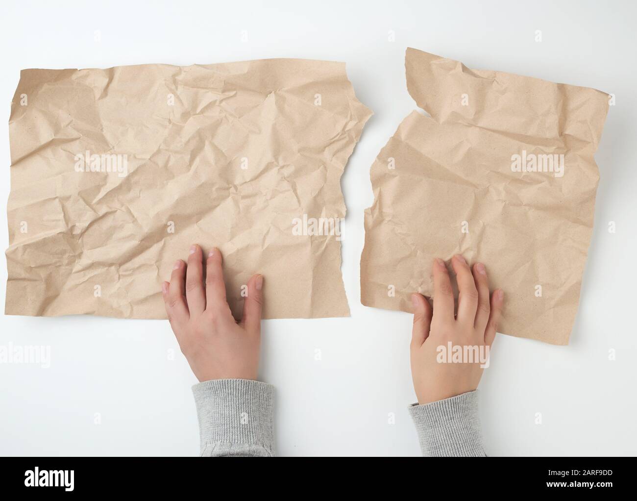 Two hands tearing paper hi-res stock photography and images - Alamy