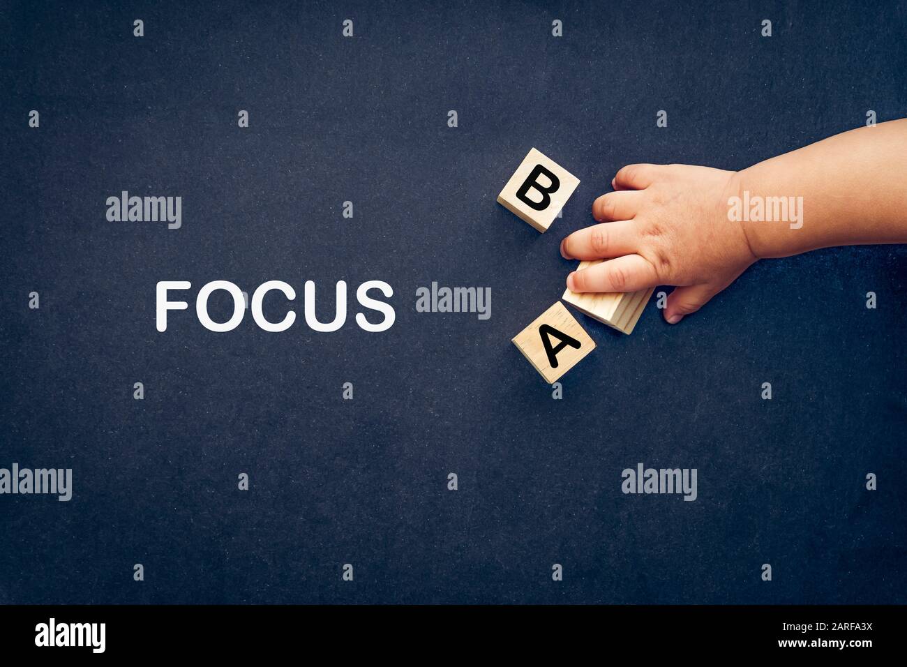 Learning Alphabet with words FOCUS, wooden cube and children hands on ...
