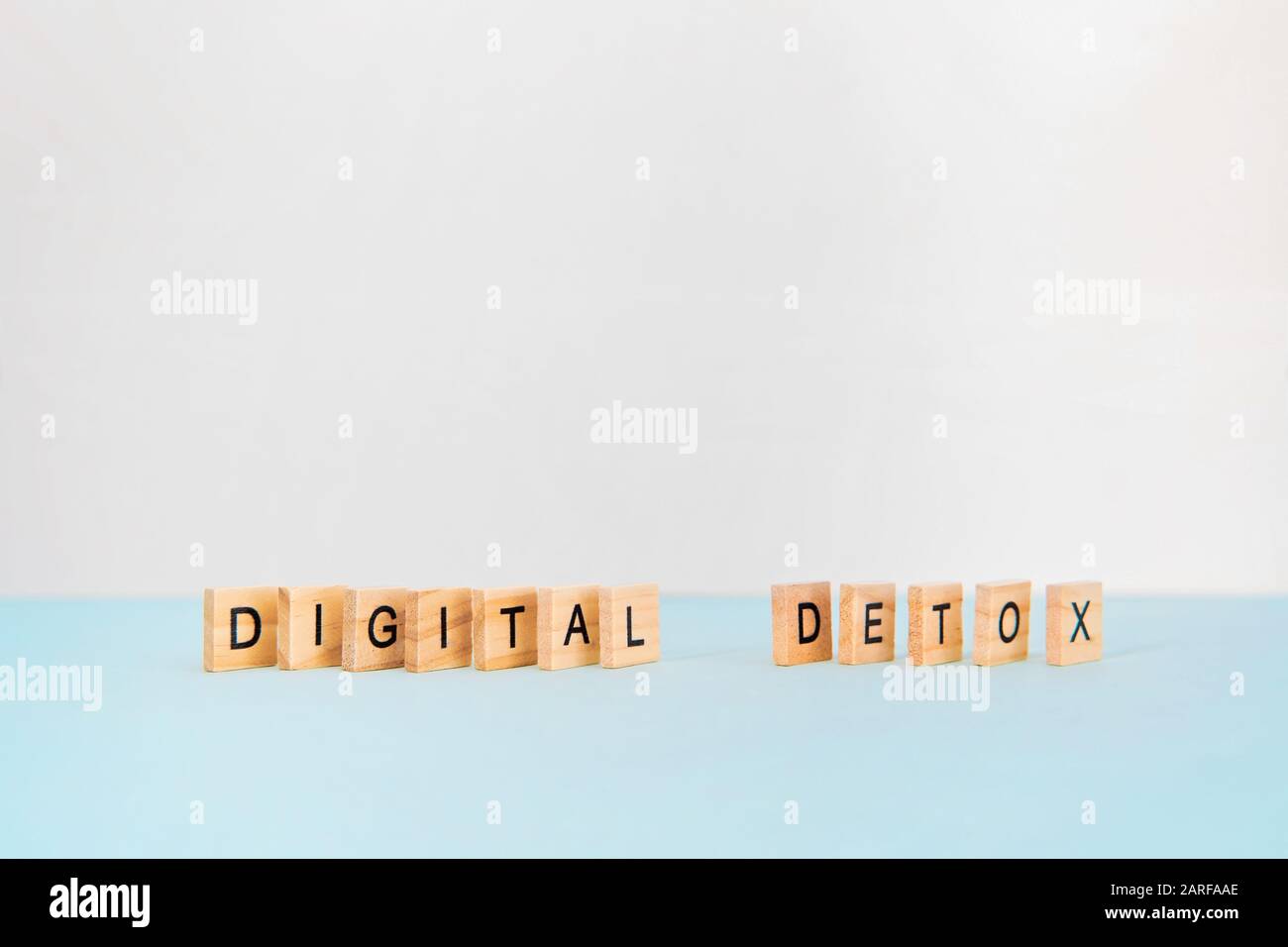 Smartphone and text digital detox on blue background. Social media ...