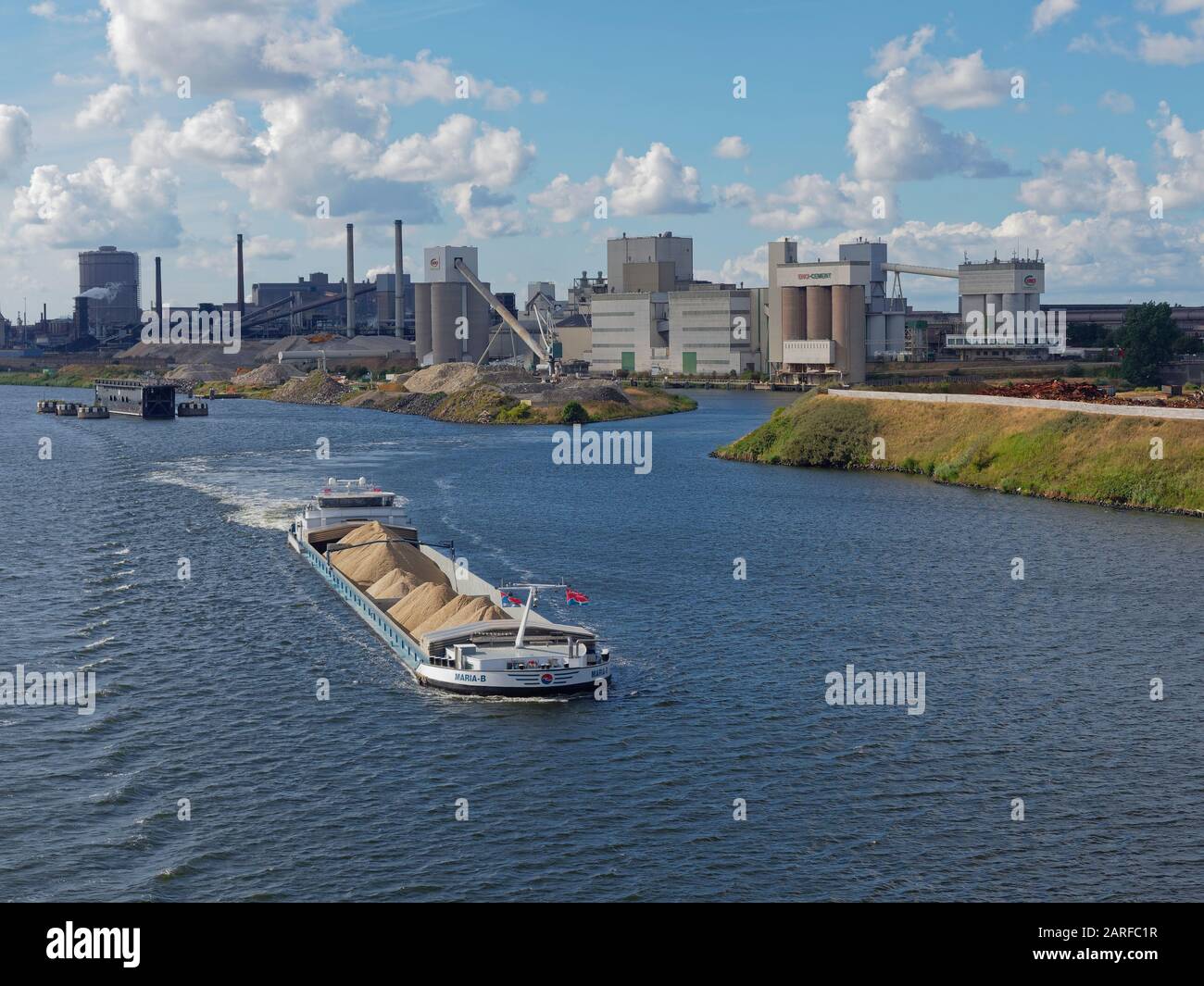 A Dutch general Cargo barge, heavily laden with sand and Gravel astern ...